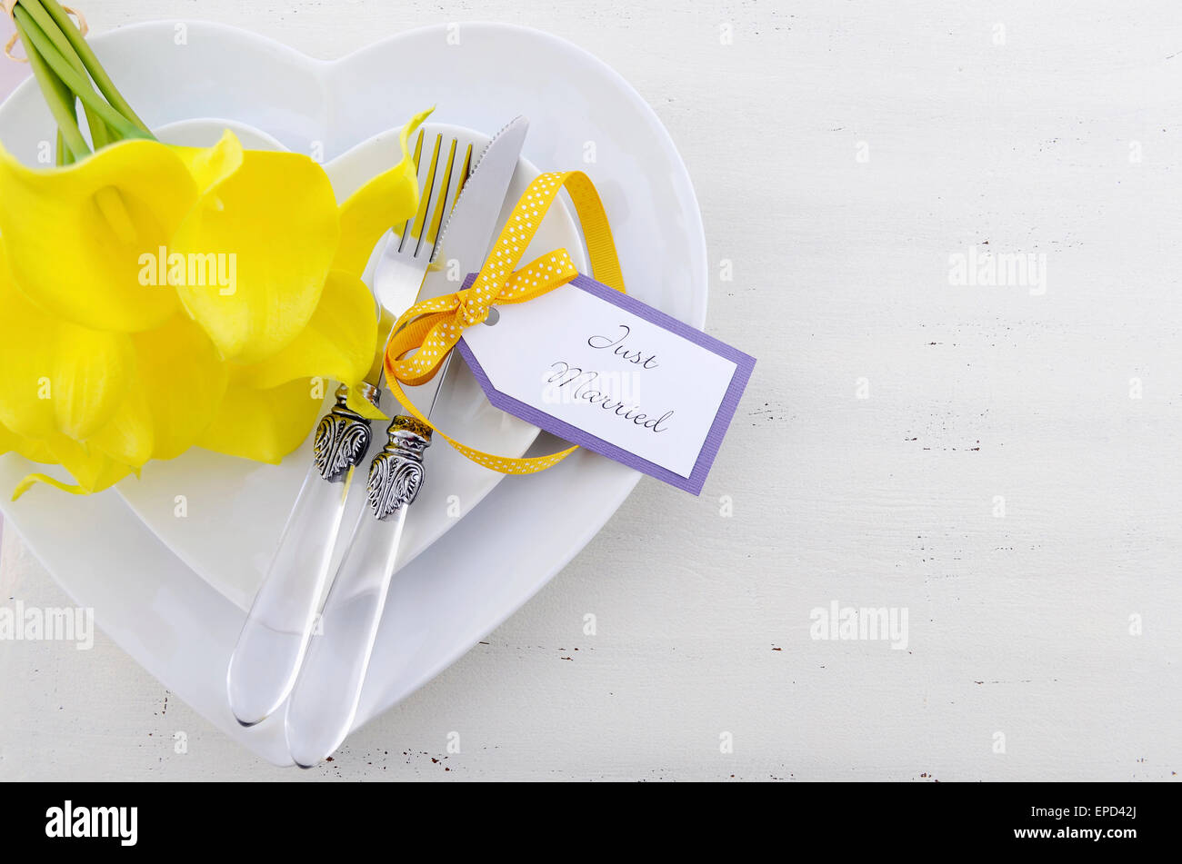 Yellow and white theme wedding table place setting with heart shape ...