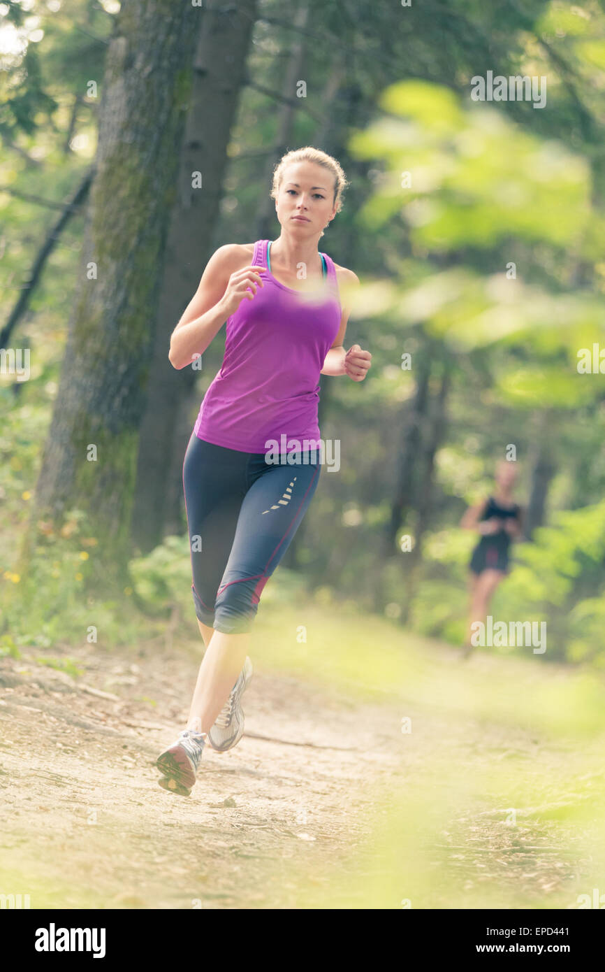 Pretty young girl runner in the forest Stock Photo - Alamy