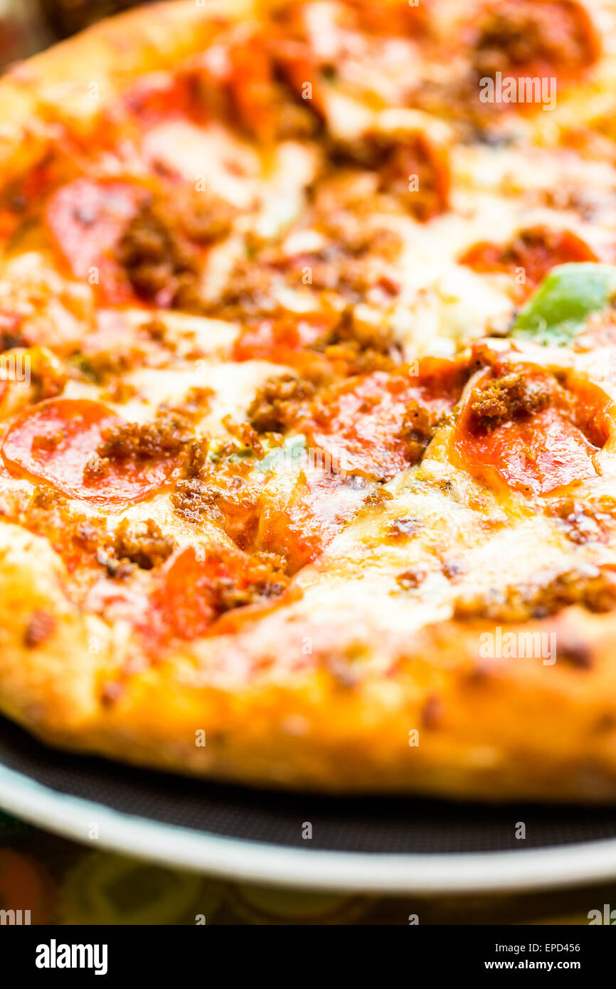 Fresh combo pizza in Italian restaurant Stock Photo - Alamy