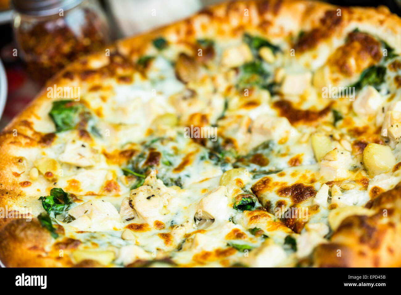 Fresh chicken pine nut pizza in Italian restaurant Stock Photo - Alamy