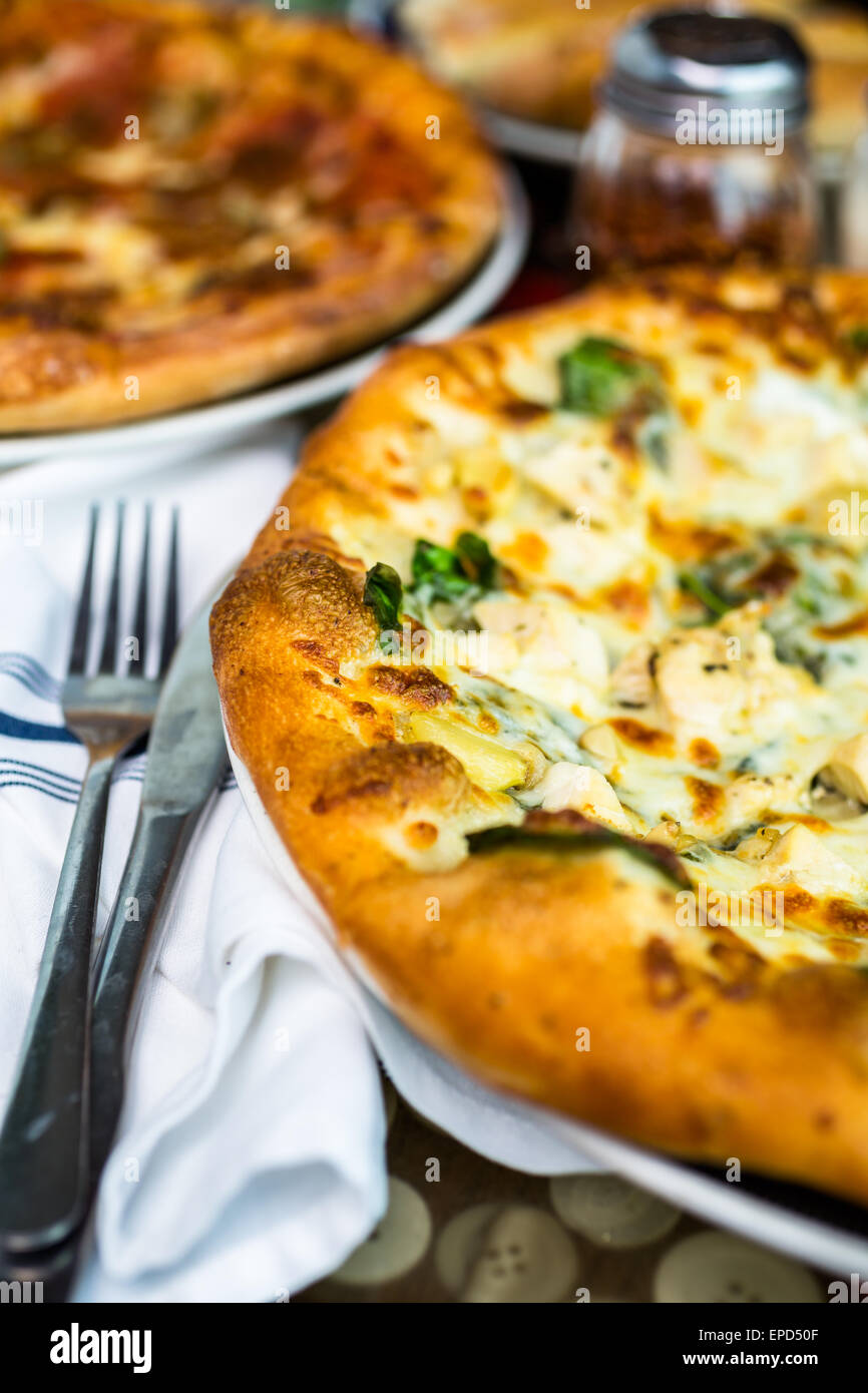 Fresh chicken pine nut pizza in Italian restaurant Stock Photo - Alamy
