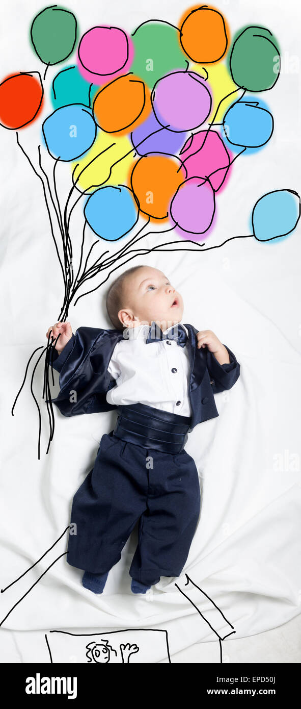 Cute baby boy decorated flying with balloons Stock Photo - Alamy