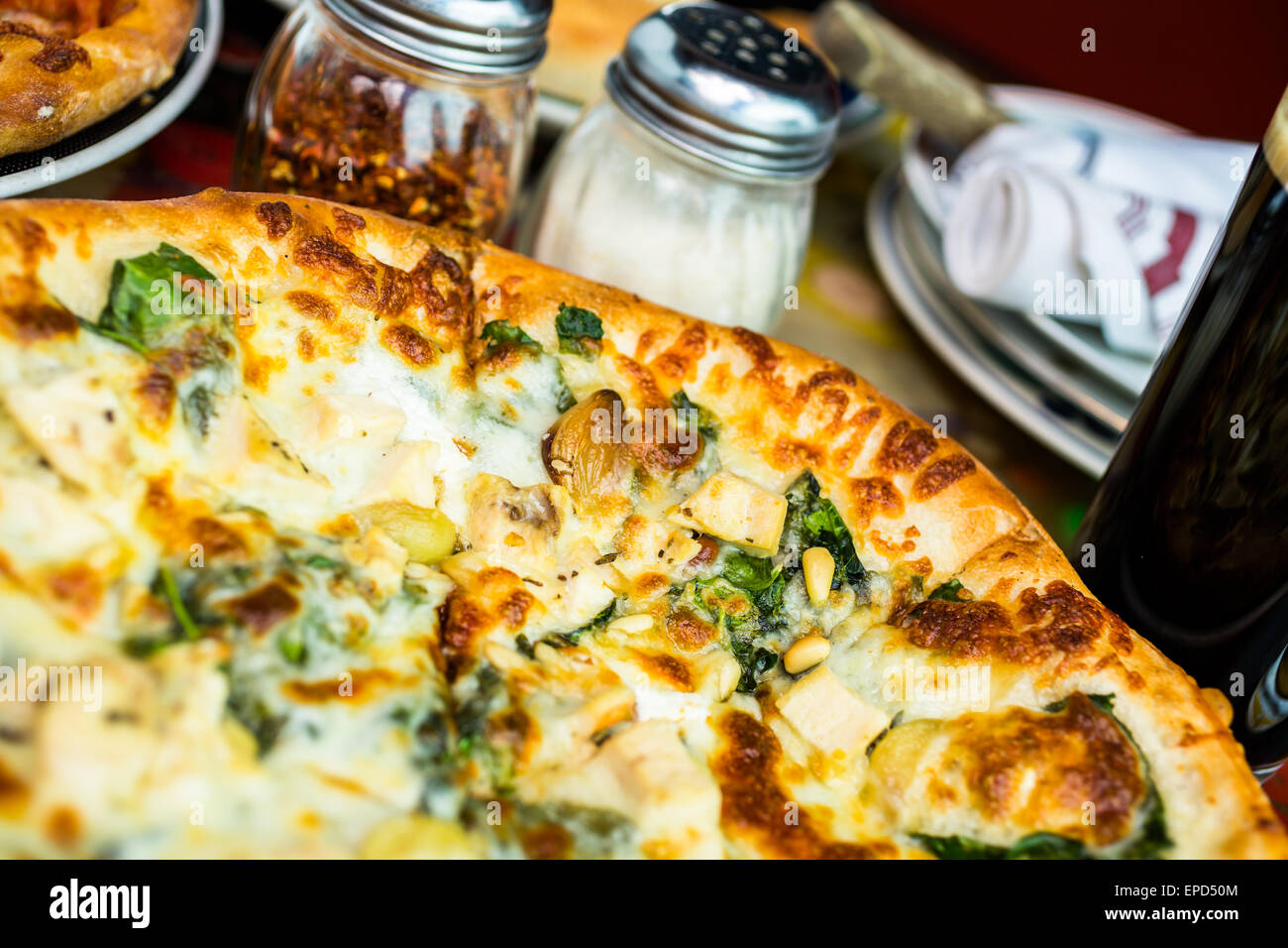 Fresh chicken pine nut pizza in Italian restaurant Stock Photo - Alamy