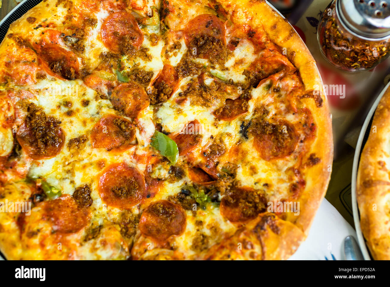 Fresh combo pizza in Italian restaurant Stock Photo - Alamy