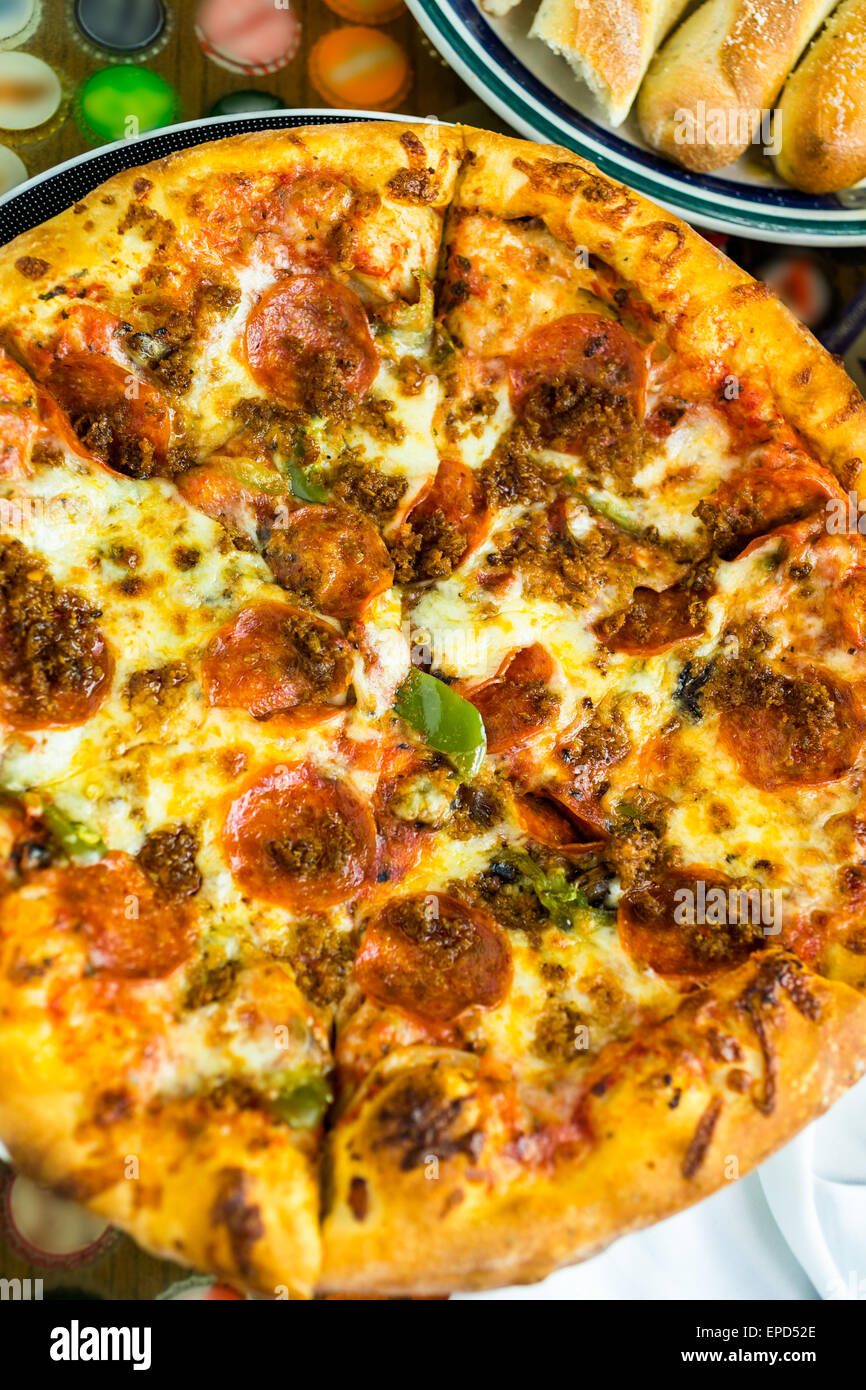 Fresh combo pizza in Italian restaurant Stock Photo - Alamy