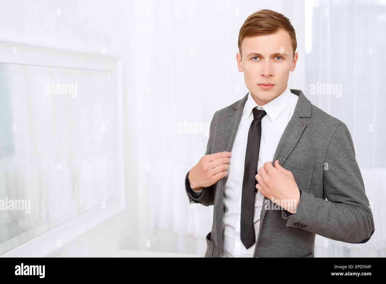 Handsome man posing in suit Stock Photo - Alamy