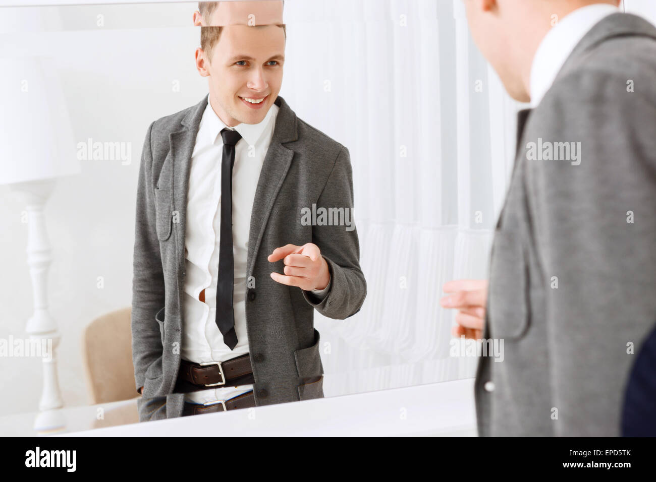 Smiling man pointing on himself in mirror Stock Photo - Alamy