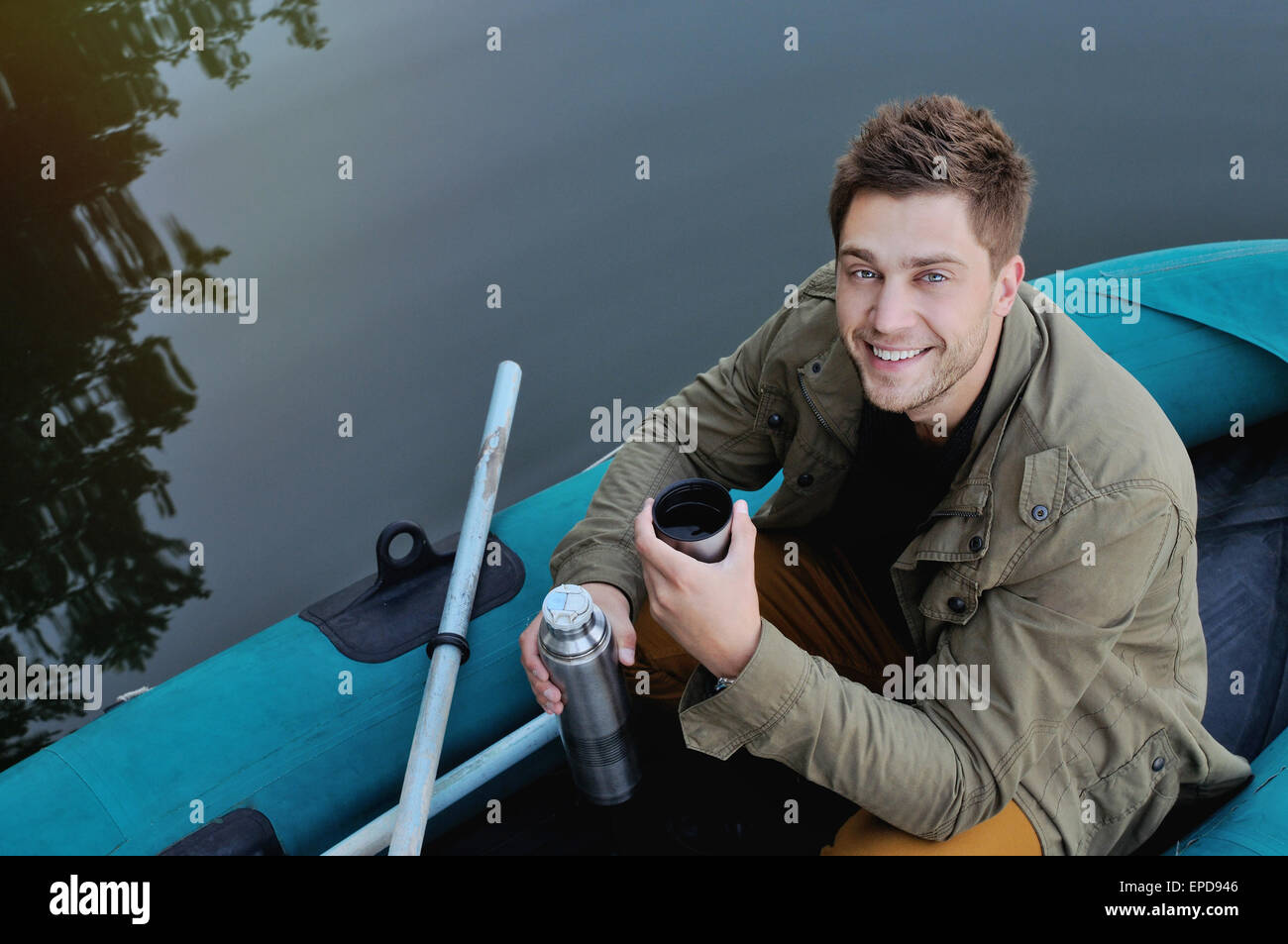 handsome attractive man on the boat at the lake on beautiful nature ...