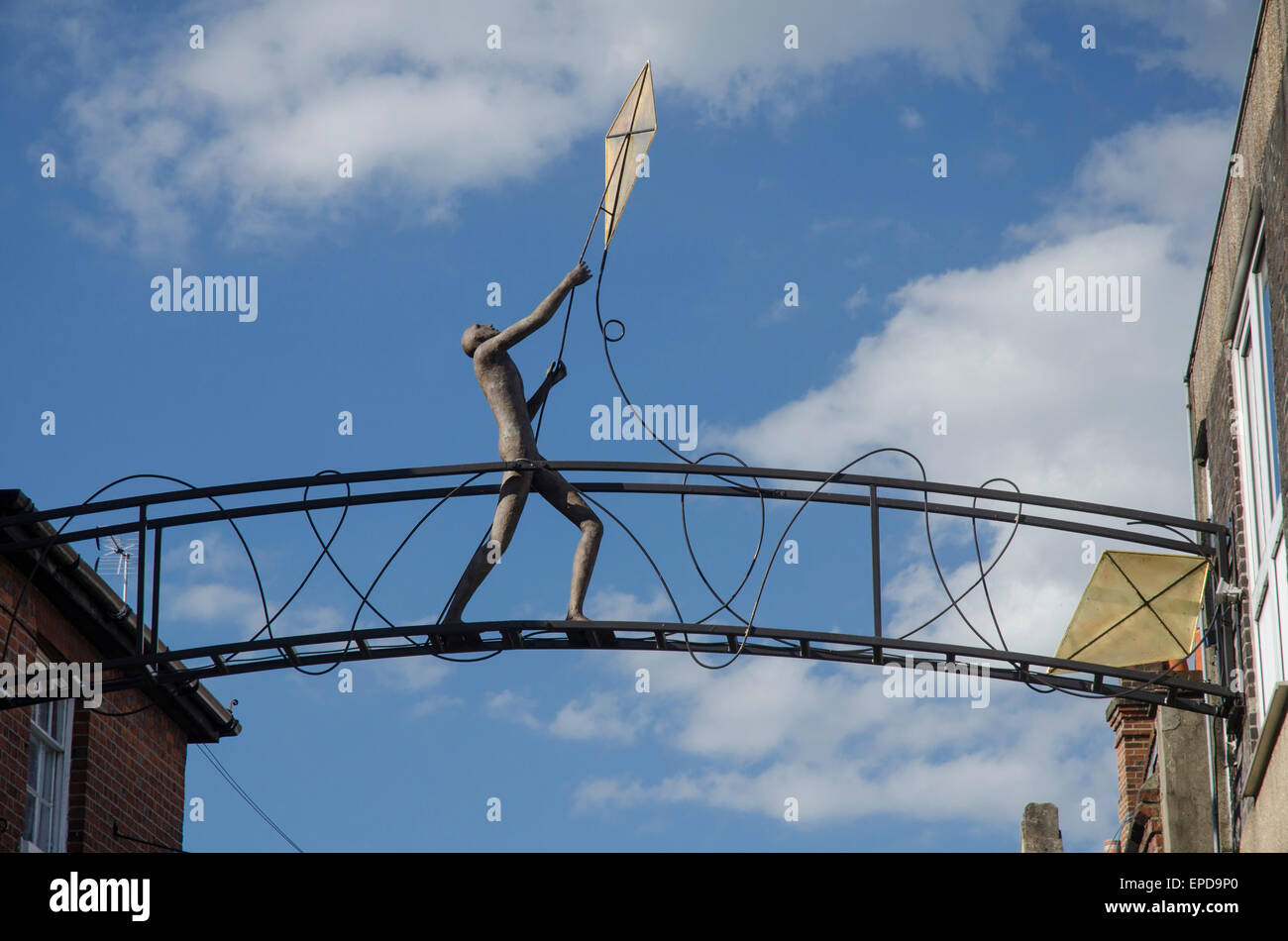 The Kite Flyer is a bronze figure of a young man flying a golden kite ...