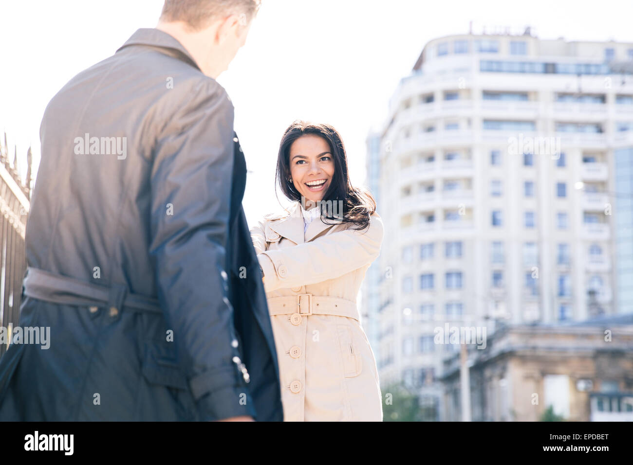 Happy beautiful woman flirting with man outdoors Stock Photo - Alamy