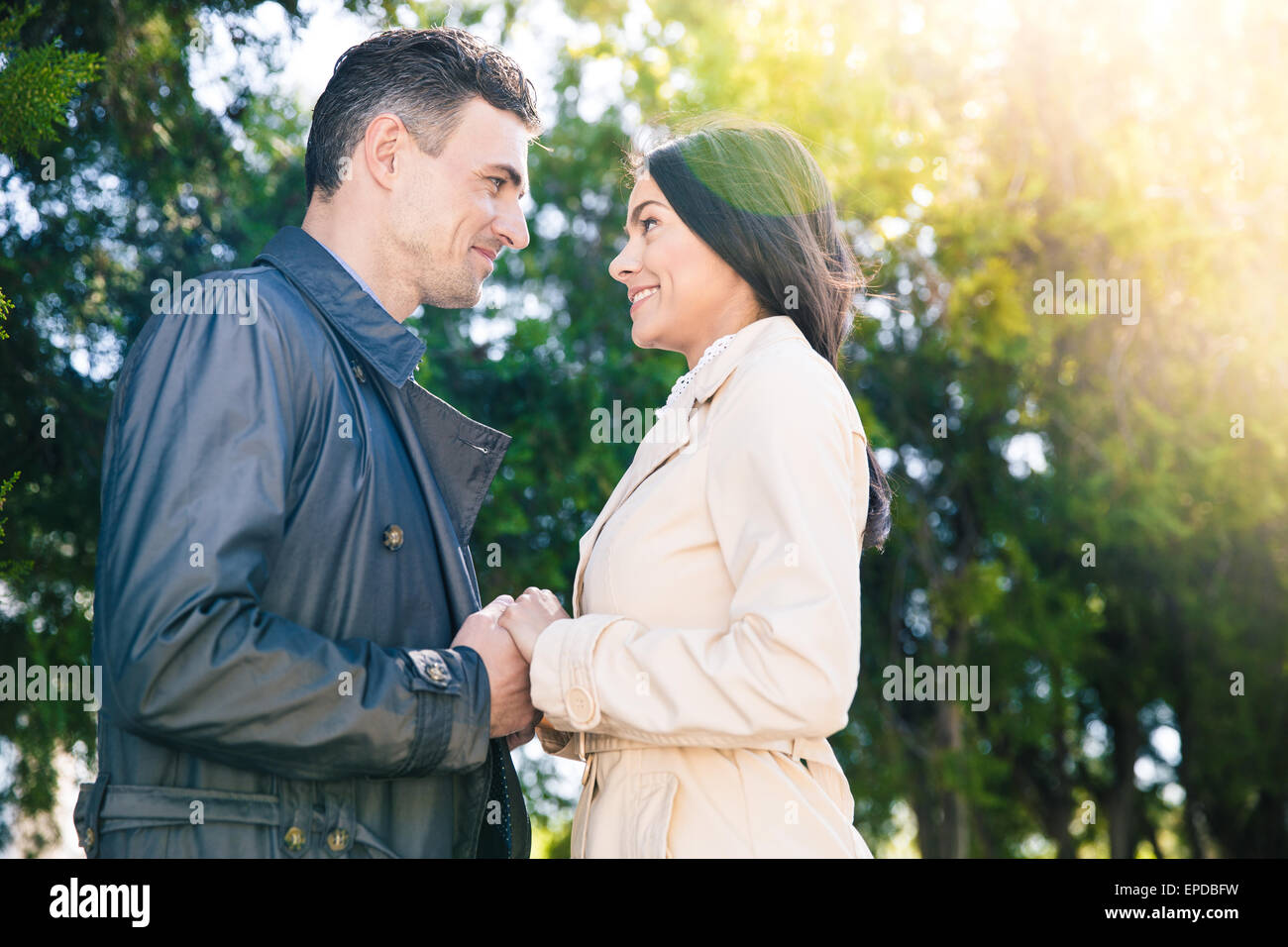 Loving girlfriend smiling while speaking with boyfriend Stock Photo - Alamy