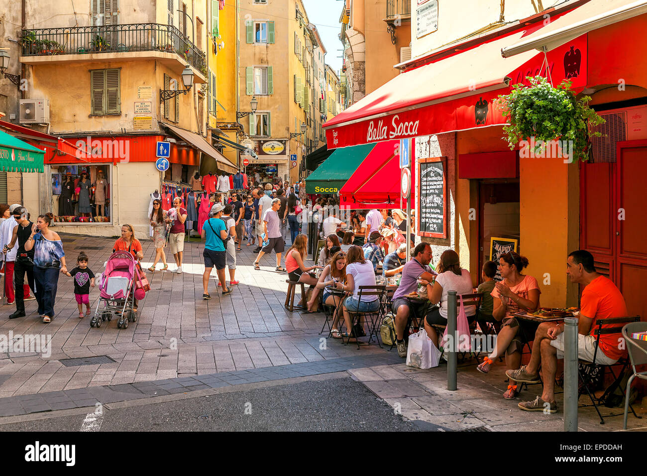 People sitting in outdoor restaurants and walking in Old City of Nice ...