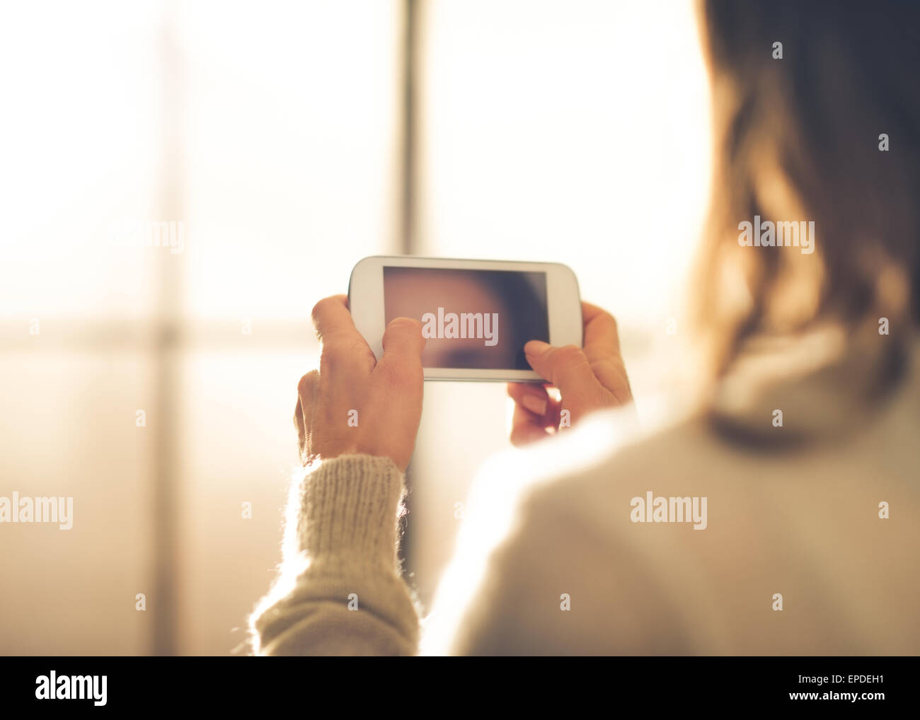 Woman texting home rear view hi-res stock photography and images - Alamy