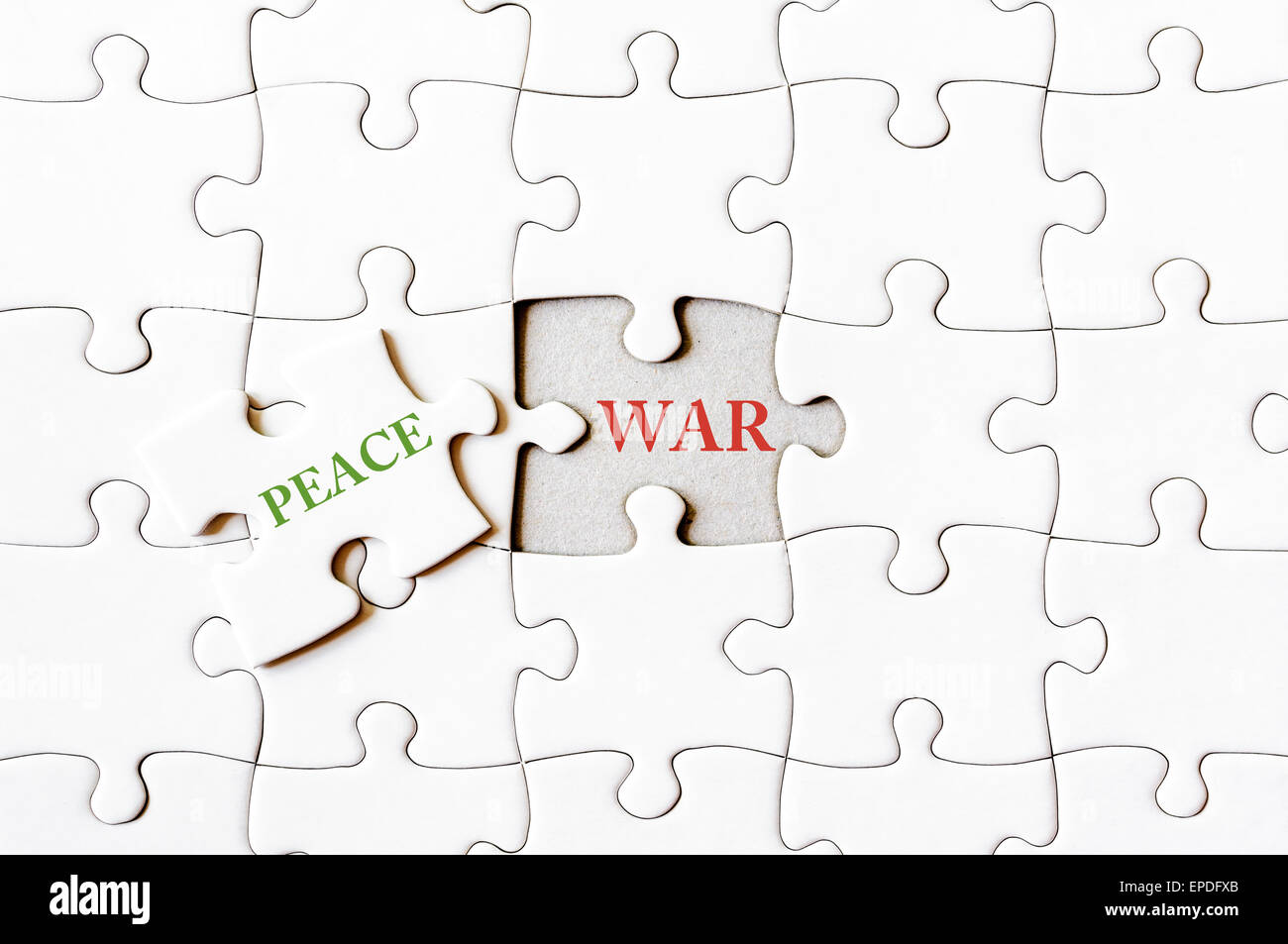 Missing jigsaw puzzle piece with word PEACE, covering text WAR ...