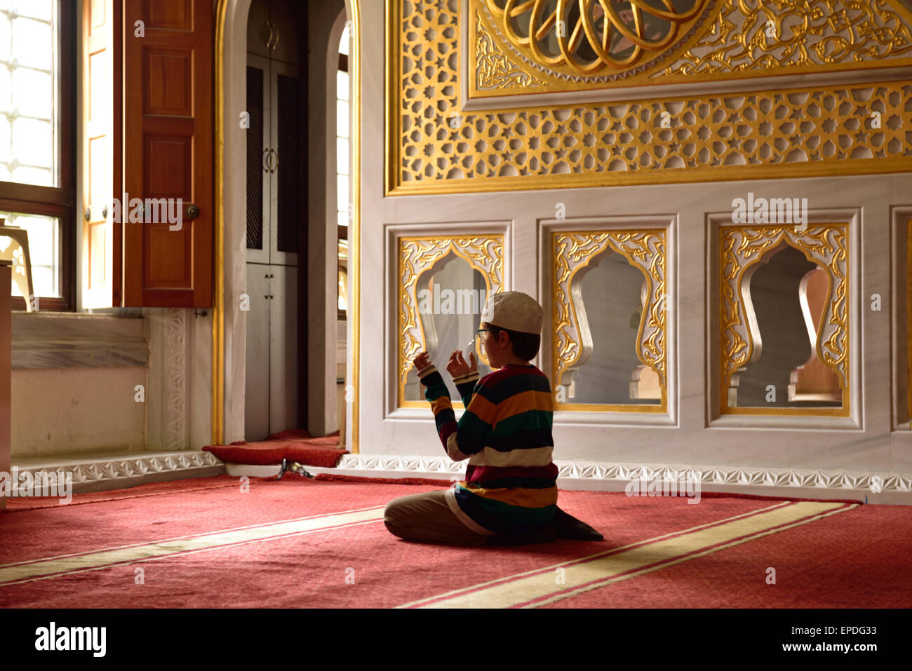 Young praying alone in front of window Stock Photo - Alamy