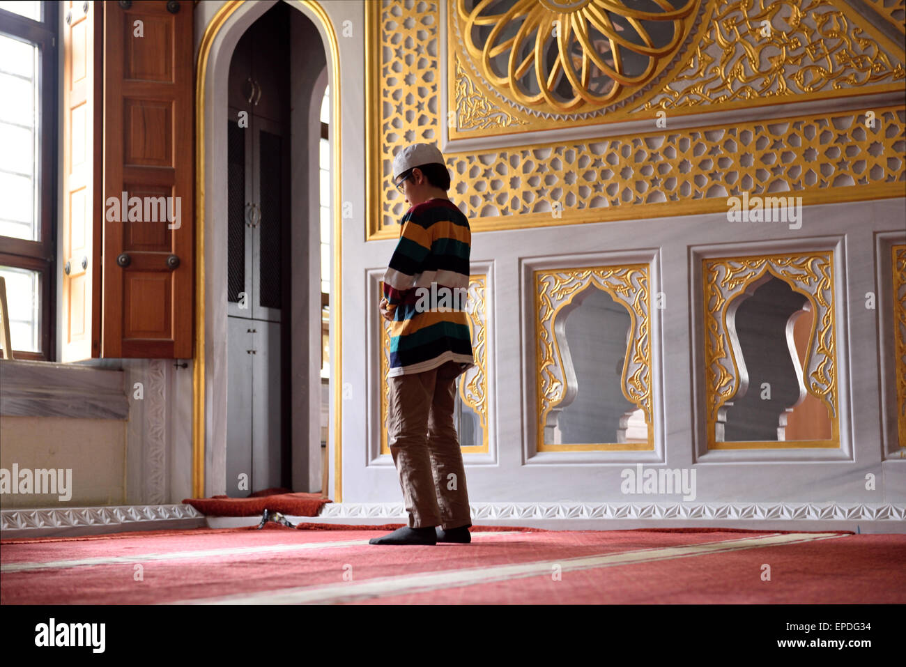 Young praying alone in front of window Stock Photo - Alamy