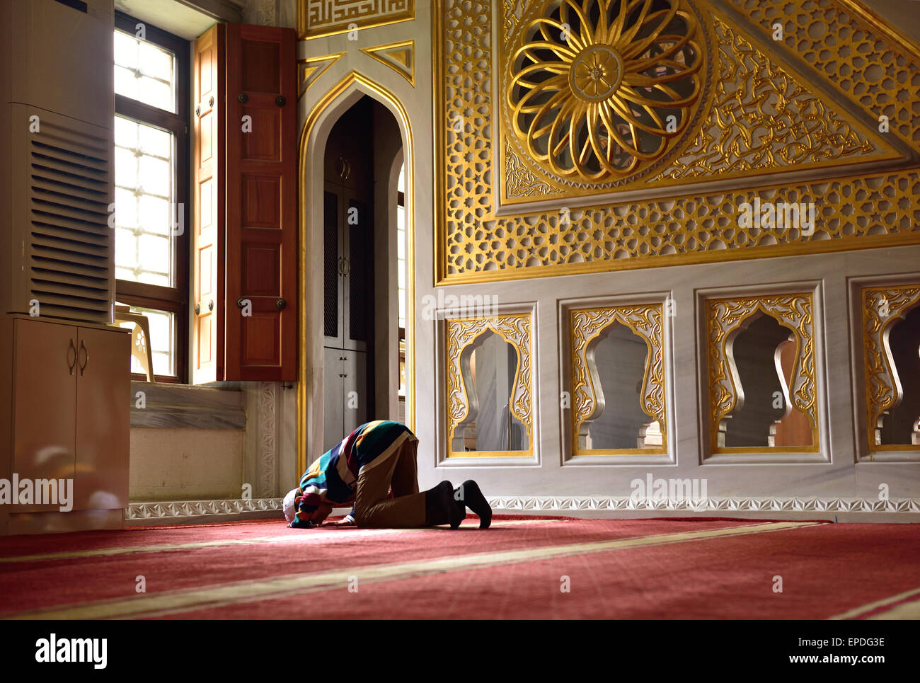 Young praying alone in front of window Stock Photo - Alamy