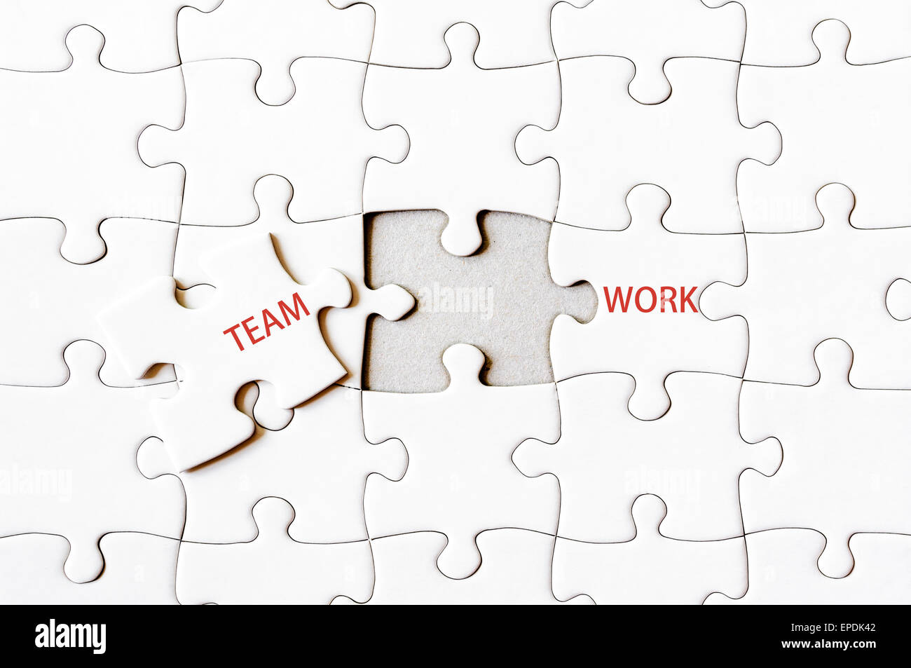 Missing jigsaw puzzle piece completing word TEAMWORK. Business concept ...