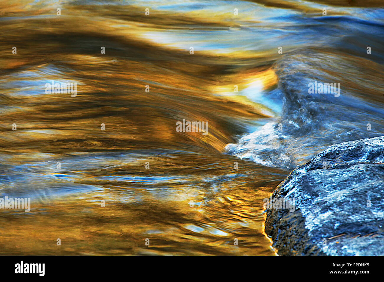 Reflection of sky and color in stream in California Stock Photo - Alamy