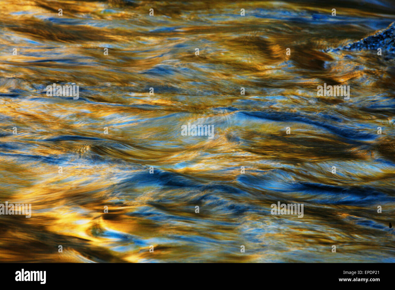 Reflection of sky and color in stream in California Stock Photo - Alamy