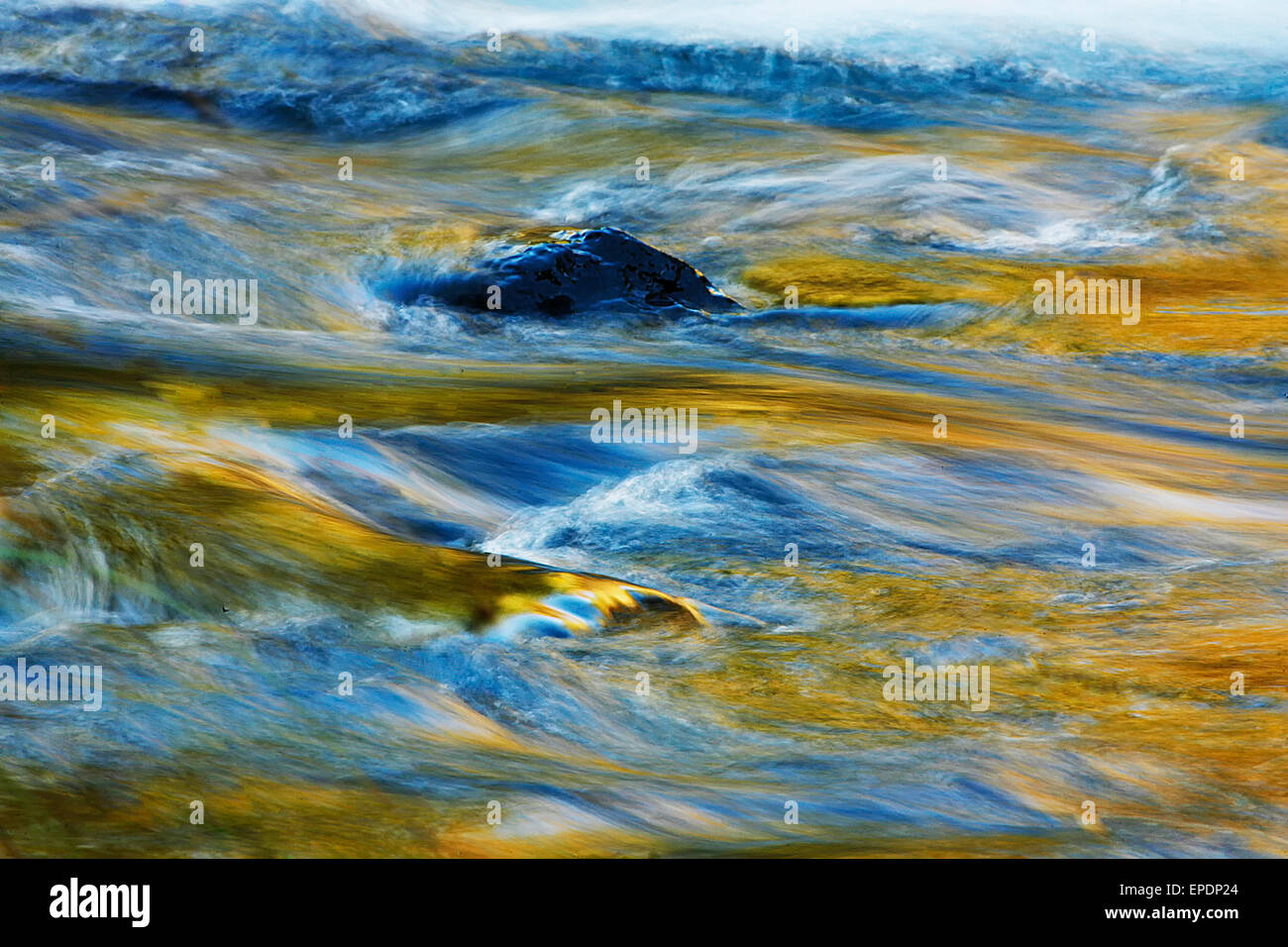 Reflection of sky and color in stream in California Stock Photo - Alamy