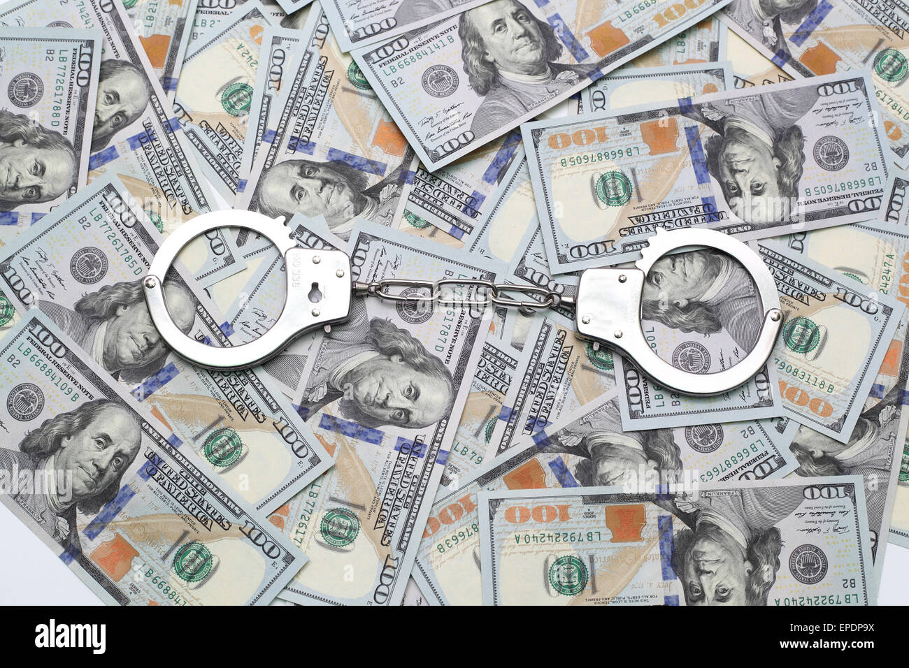 handcuffs on a pack of dollars Stock Photo - Alamy