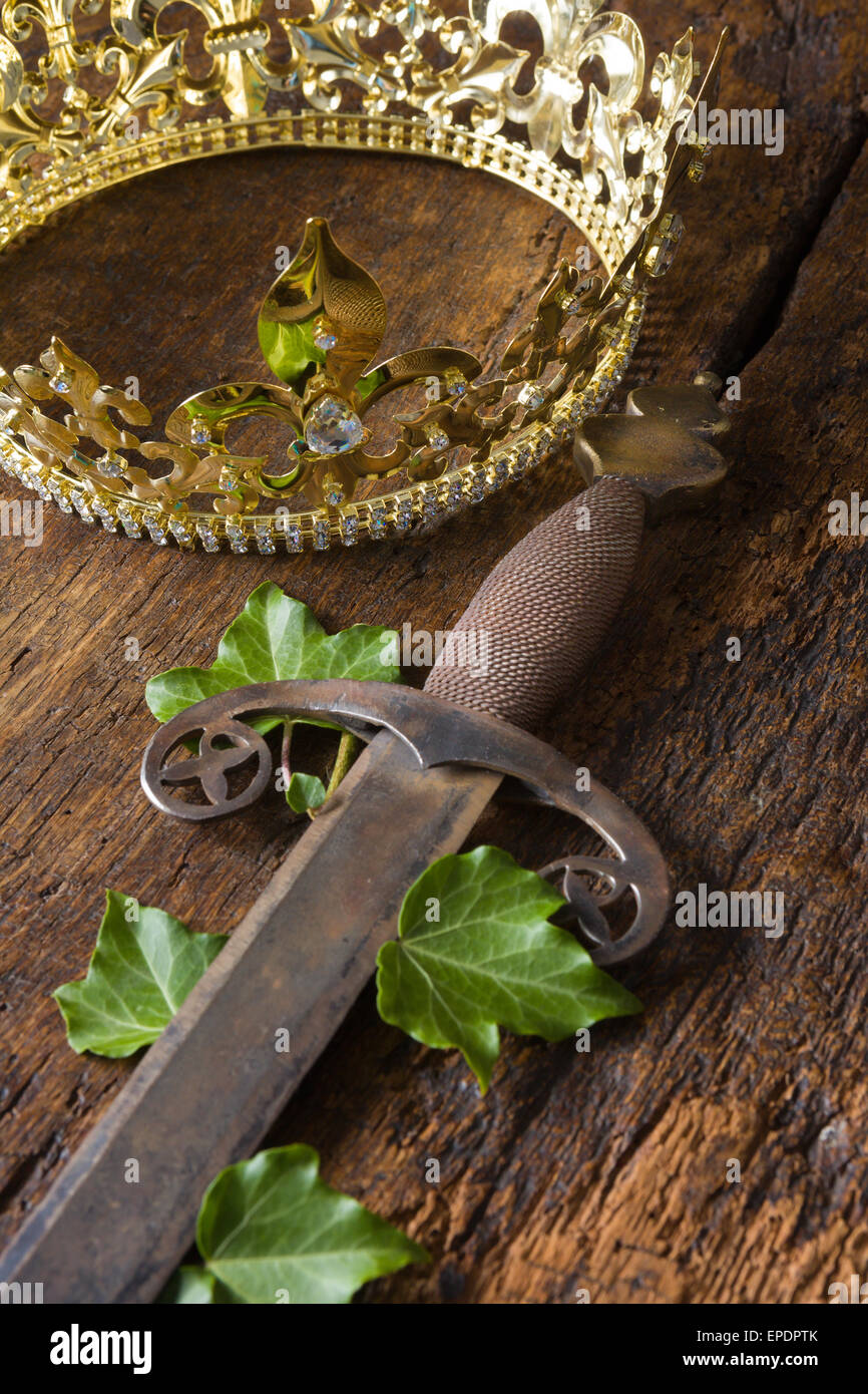 Antique medieval sword and golden crown decorated with ivy Stock Photo ...