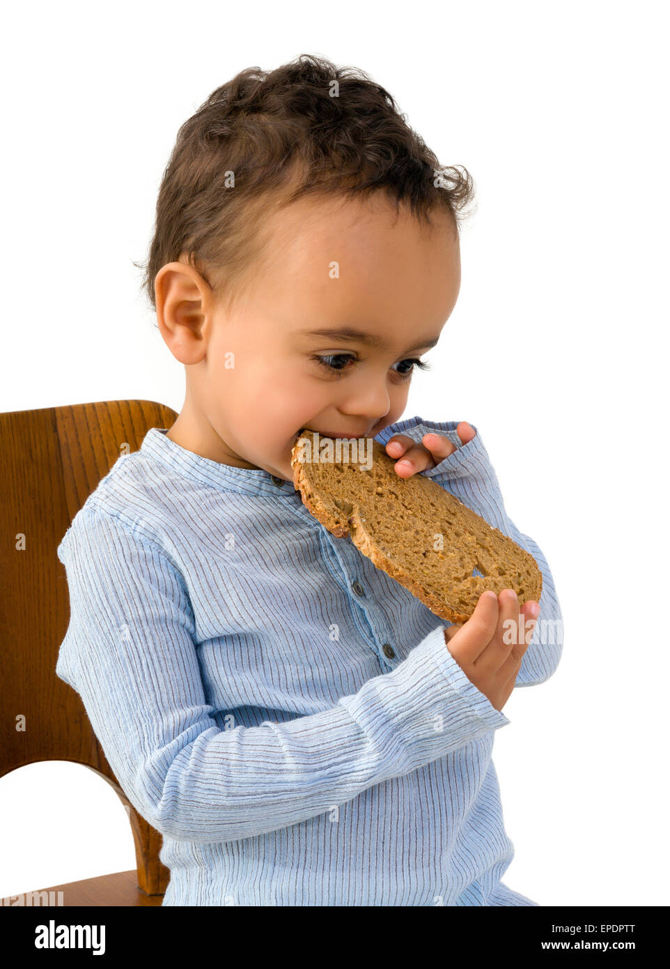 Cute little African boy eating a slice of wholemeal bread Stock Photo ...
