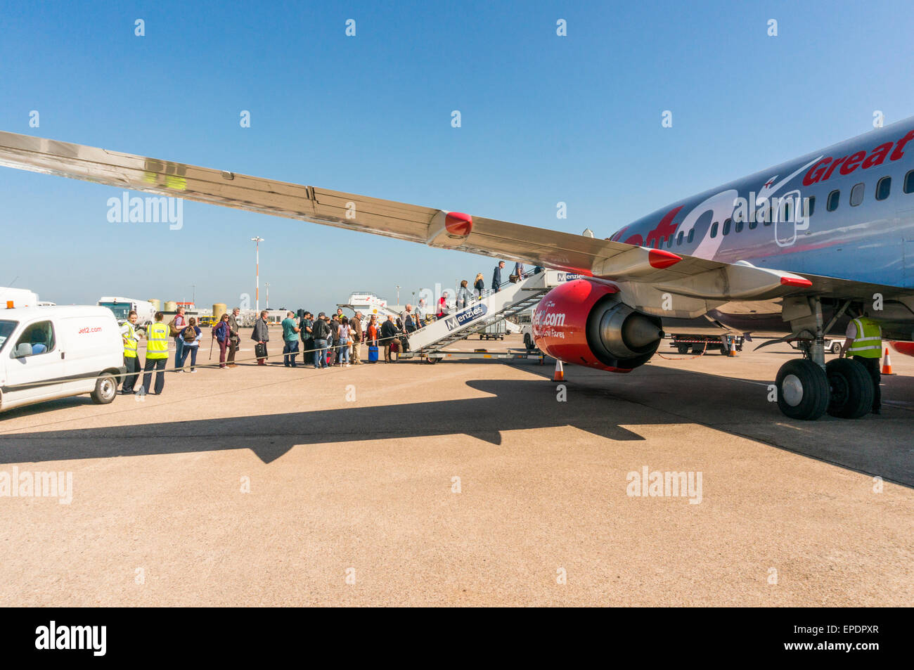 Passengers walking up steps to board a Jet 2.Com Boeing 737 aeroplane ...