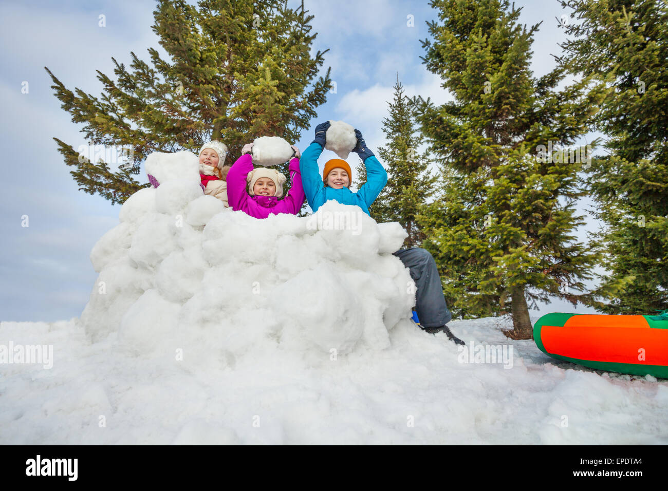 Group of happy kids play snowballs game together Stock Photo - Alamy
