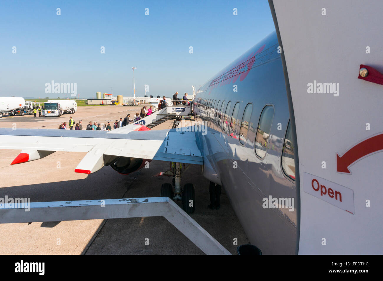 Passengers walking up steps to board a Jet 2.Com Boeing 737 aeroplane ...