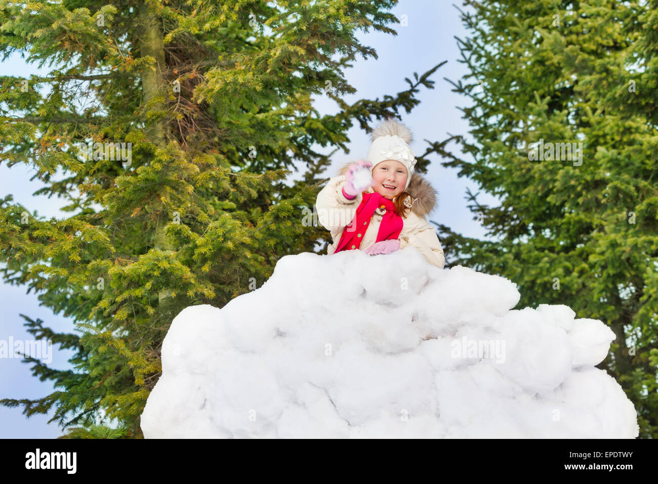 Beautiful small girl holds snowball in the forest Stock Photo - Alamy