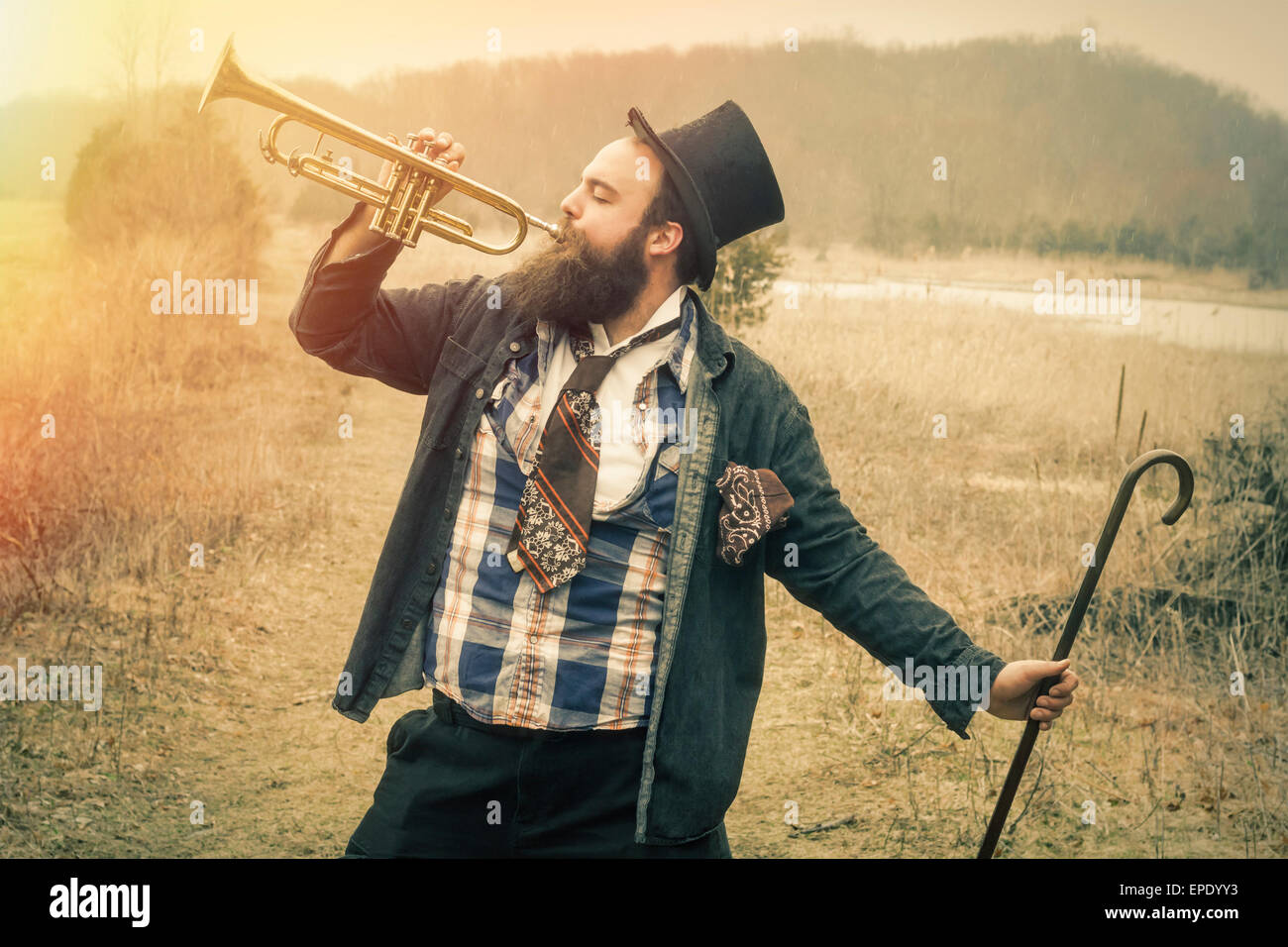 Stylish bearded gypsy plays trumpet on a wilderness path Stock Photo ...
