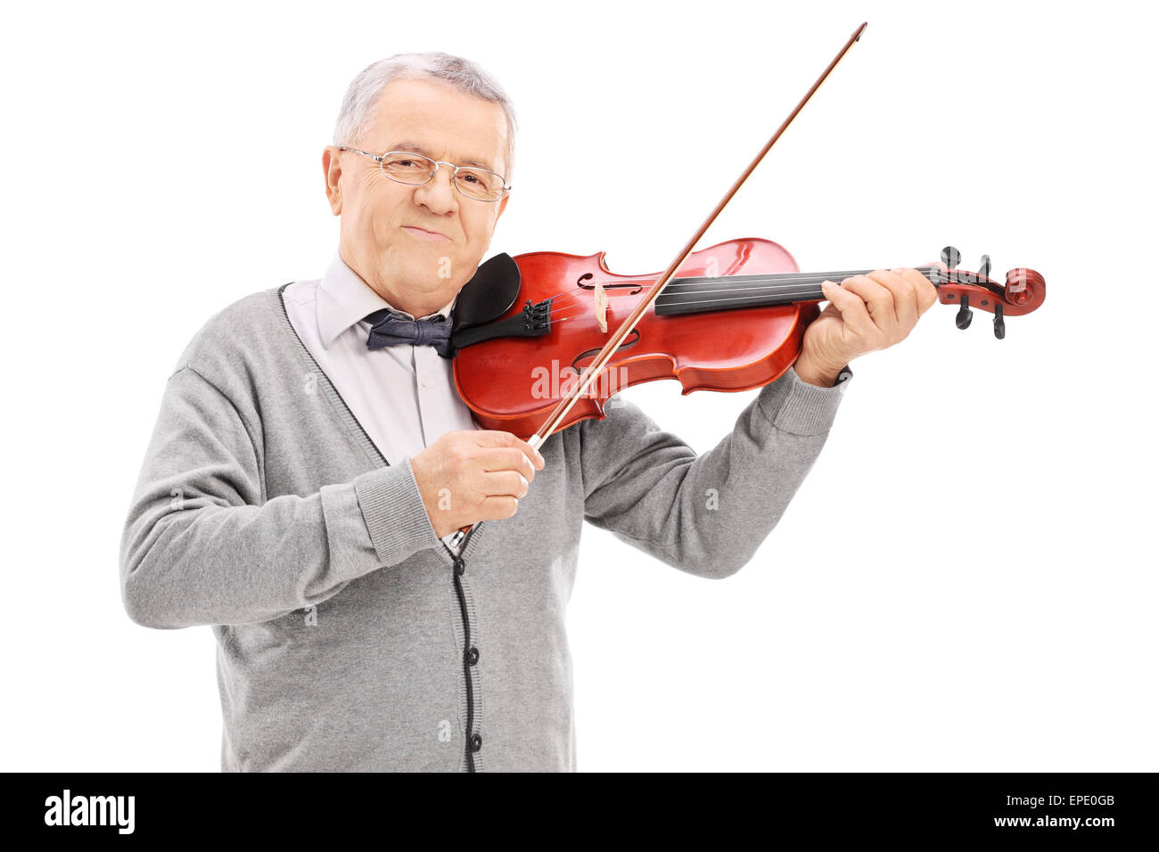 Senior musician playing a violin with a wand isolated on white ...