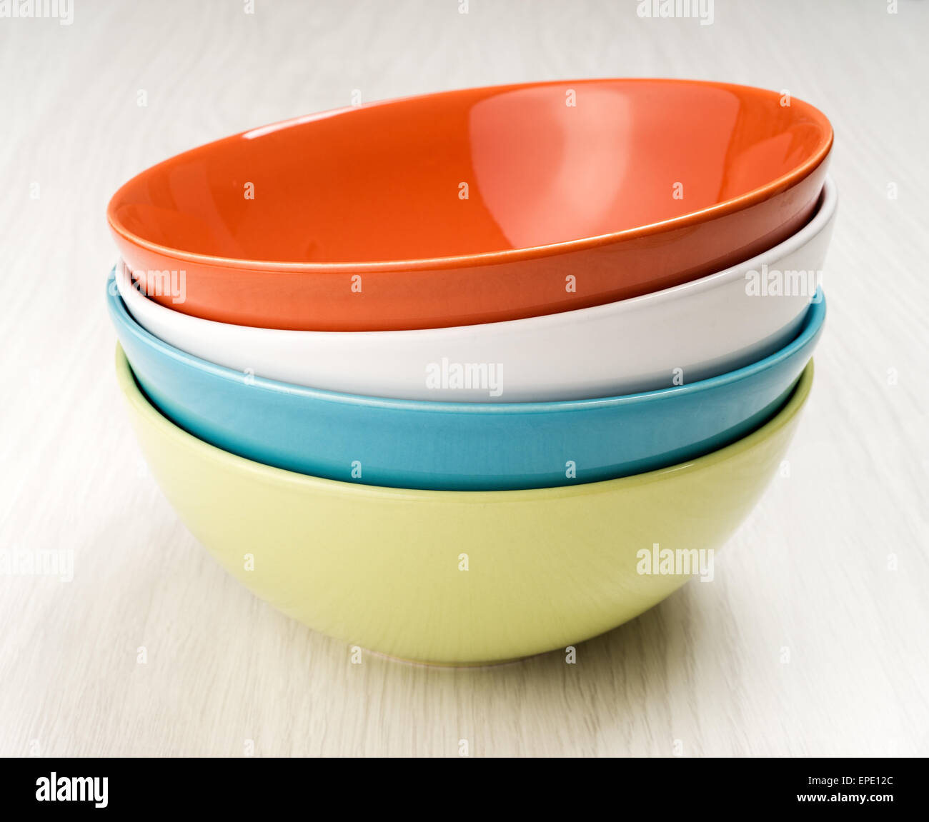 Colorful plates on the dining table light Stock Photo - Alamy