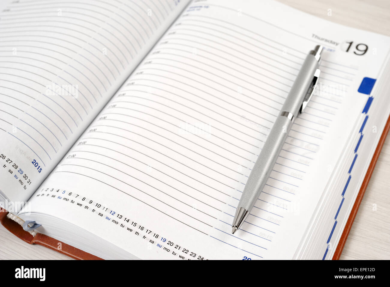 Diary with a pen on a white background closeup Stock Photo - Alamy