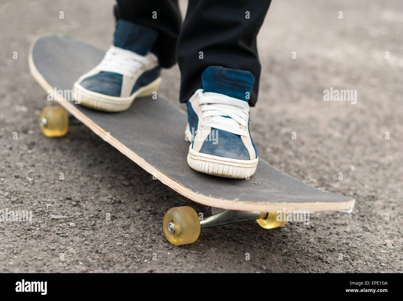 Skateboarder rides on a skateboard feet in sneakers Stock Photo - Alamy