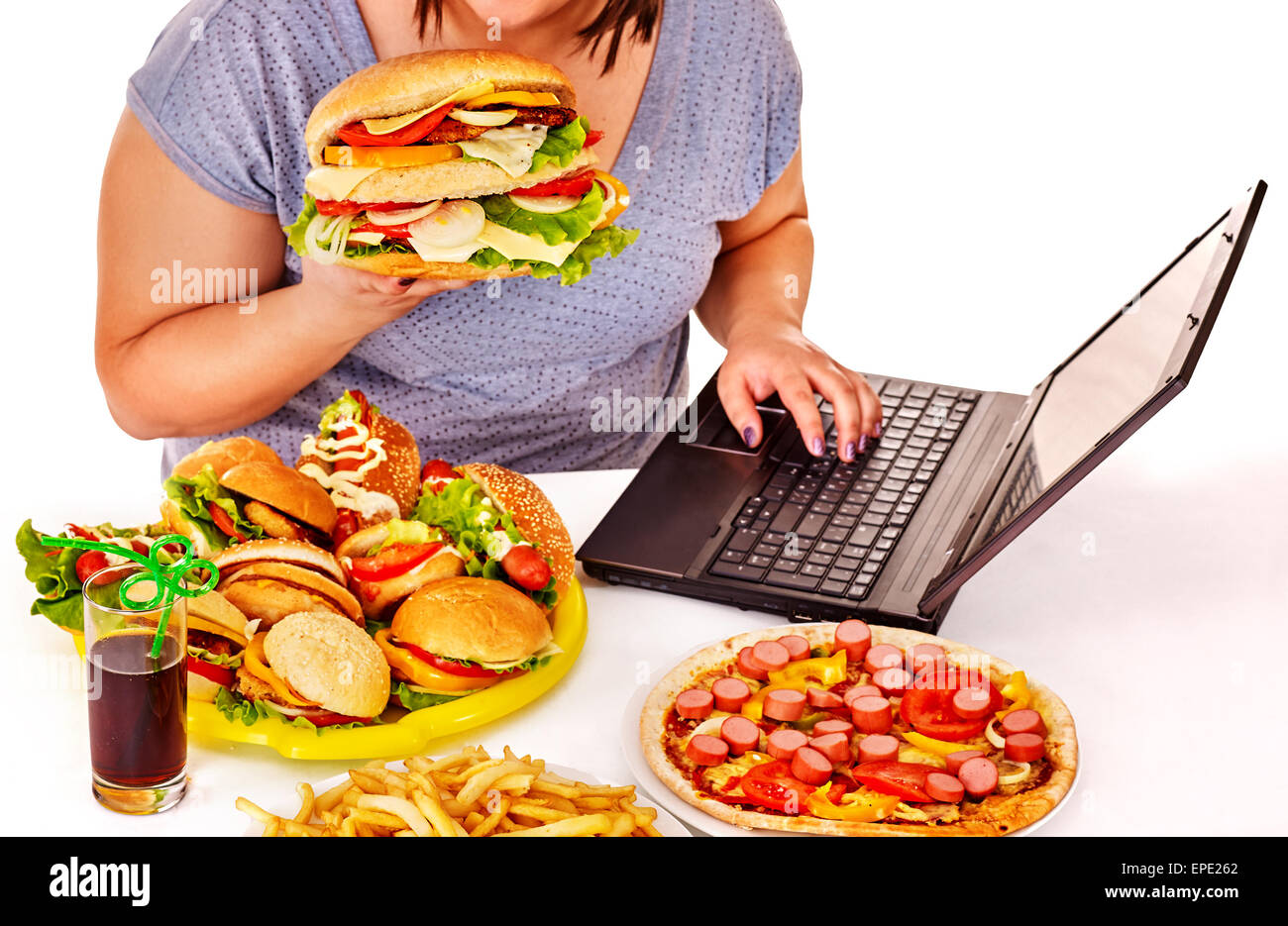 Woman eating junk food Stock Photo - Alamy