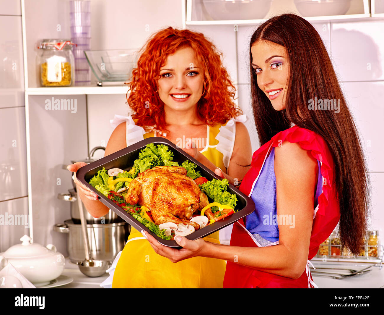 Women cooking chicken at kitchen Stock Photo - Alamy