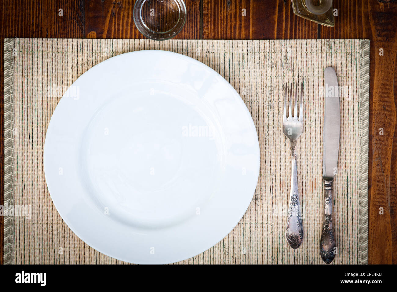 Table setting for two with empty plates - rustic wooden table Stock ...