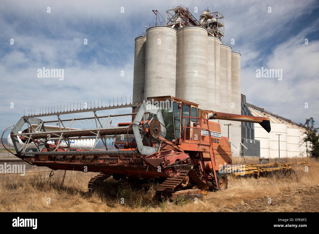 Rice silo and rice combine Stock Photo - Alamy