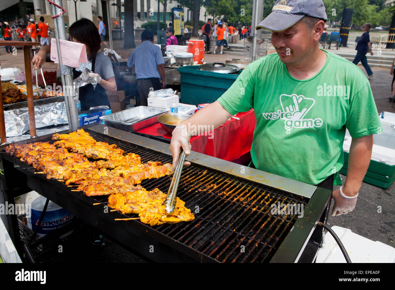 Man grilling barbecue chicken skewers - USA Stock Photo - Alamy