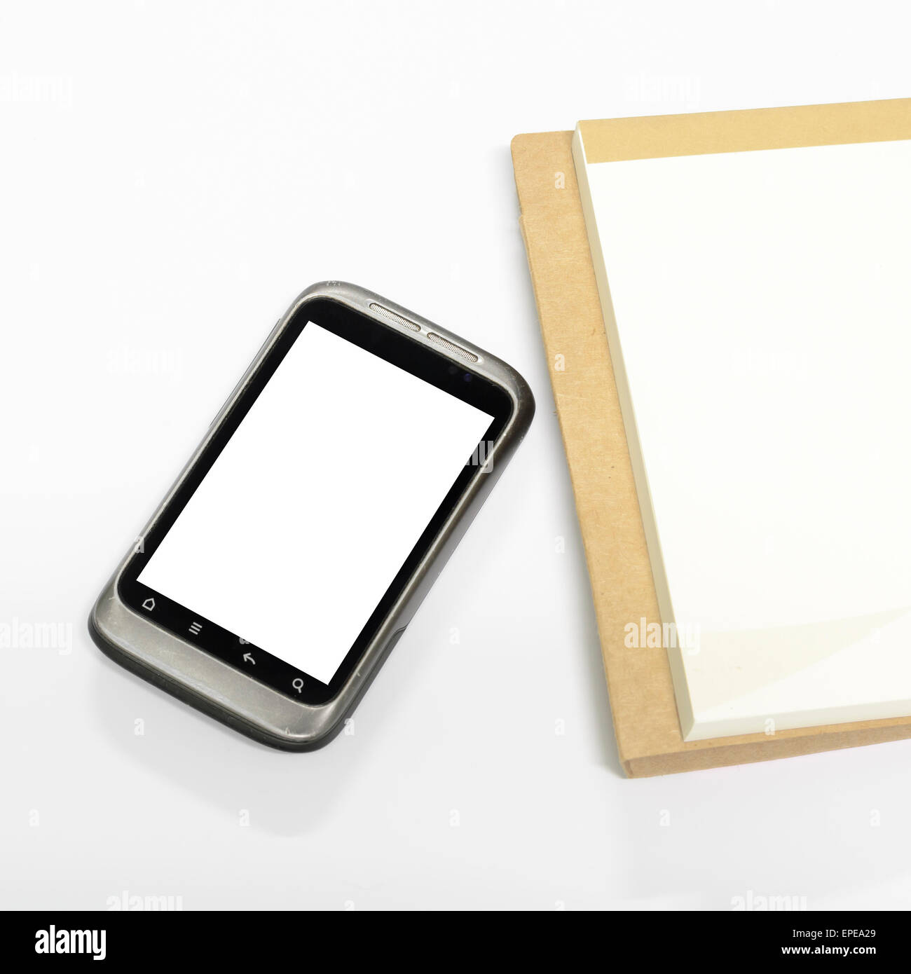 used smartphone with note book on a white background Stock Photo - Alamy