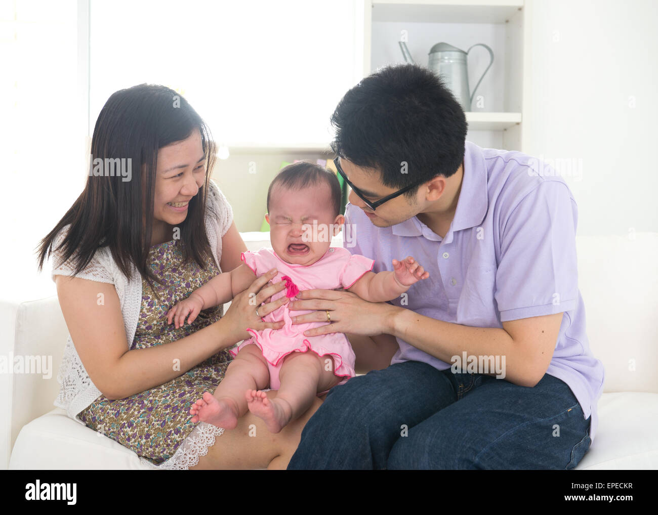 asian parent with crying baby Stock Photo - Alamy