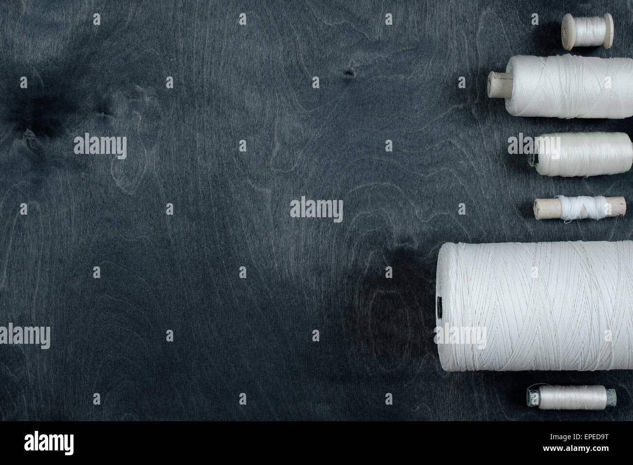 Spools of thread on the dark background Stock Photo - Alamy