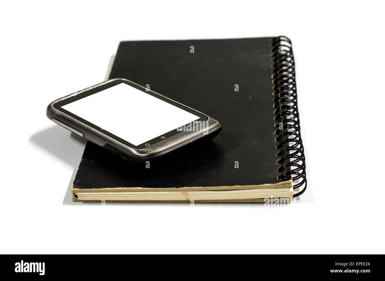smartphone on note book on a white background Stock Photo - Alamy