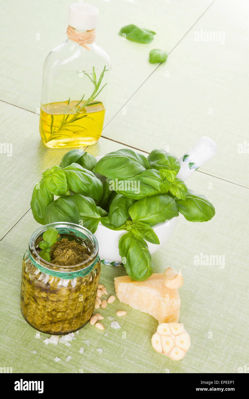 Basil pesto with ingredients. Garlic, basil pesto, extra virgin olive ...
