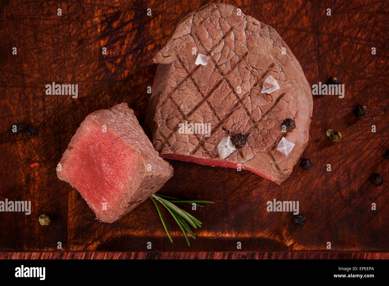 Luxurious steak background. Rare mignon beefsteak with peppercorn and ...