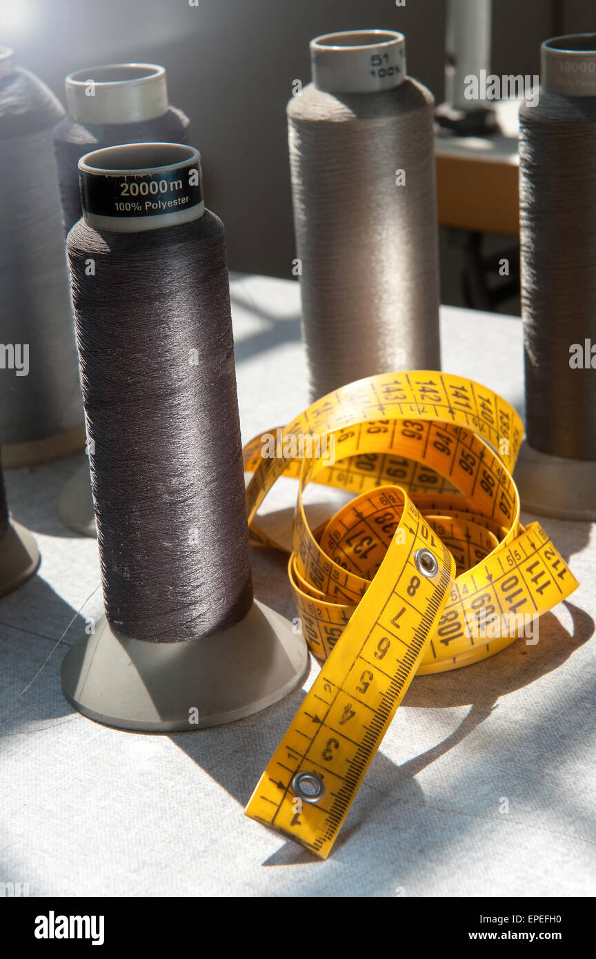 Tape measure and spools of yarn Stock Photo - Alamy
