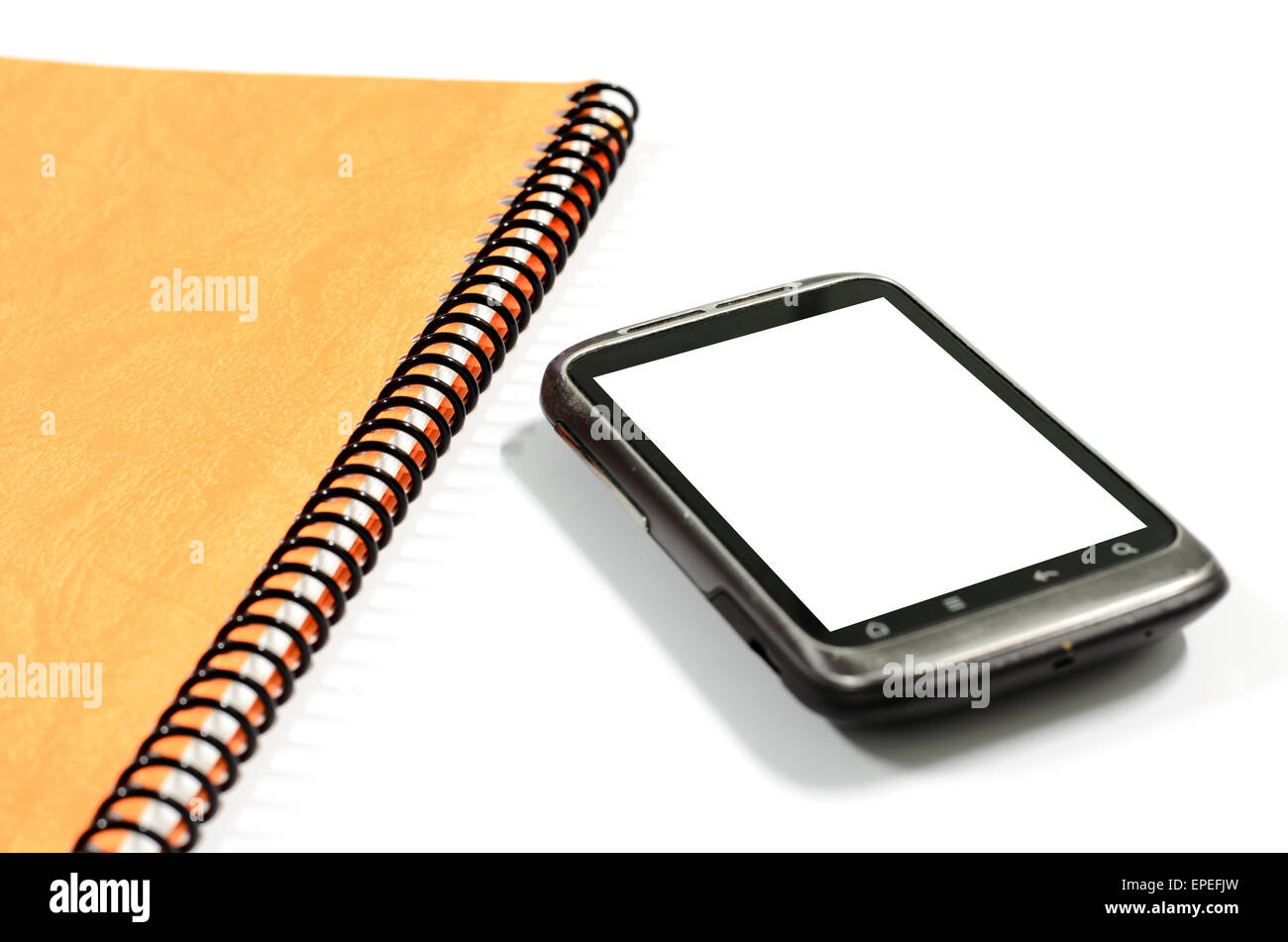 smartphone with orange note book on a white background Stock Photo - Alamy